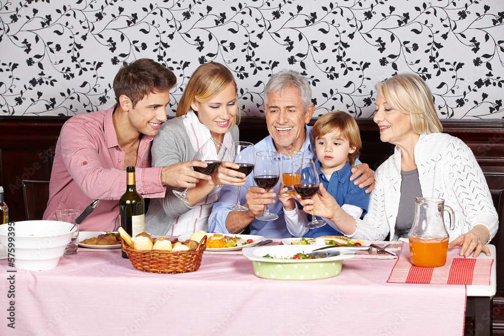 Happy family at dinner table Stock Photo | Adobe Stock