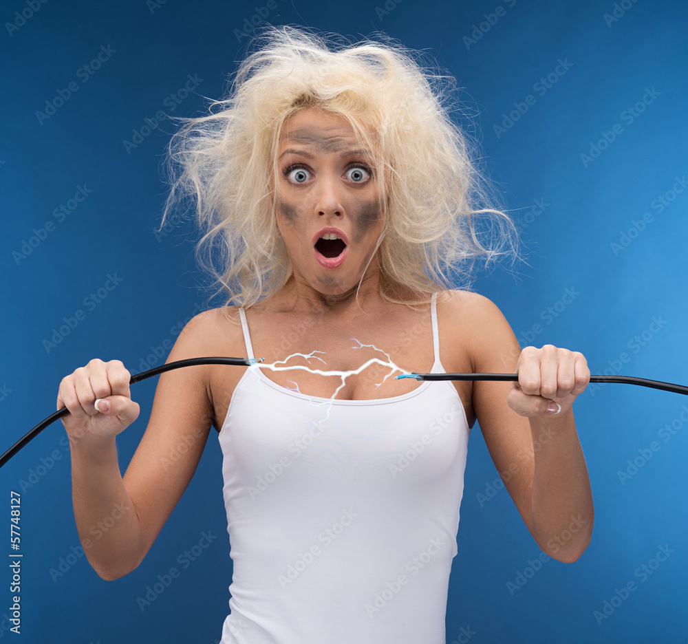 Funny girl having problem with electricity. Stock-Foto | Adobe Stock