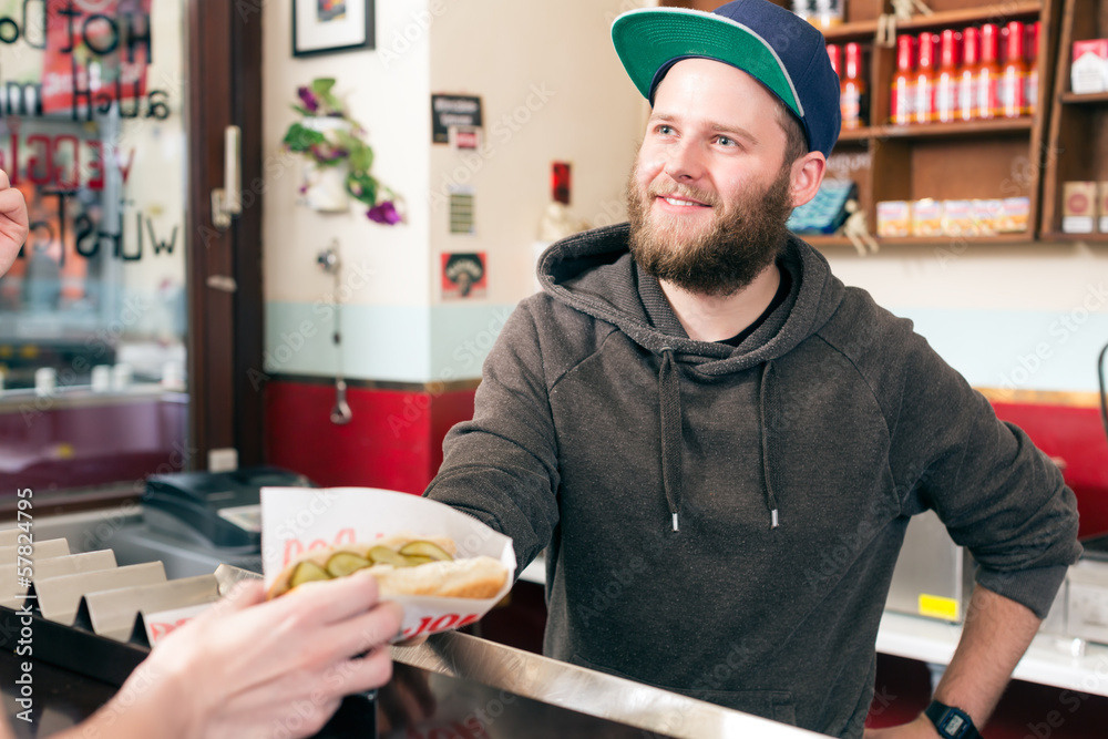 salesman with hotdog in fast food snack bar Stock Photo | Adobe Stock