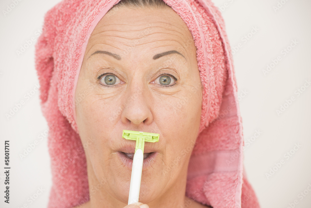 Funny woman shaving face with razor Stock Photo | Adobe Stock