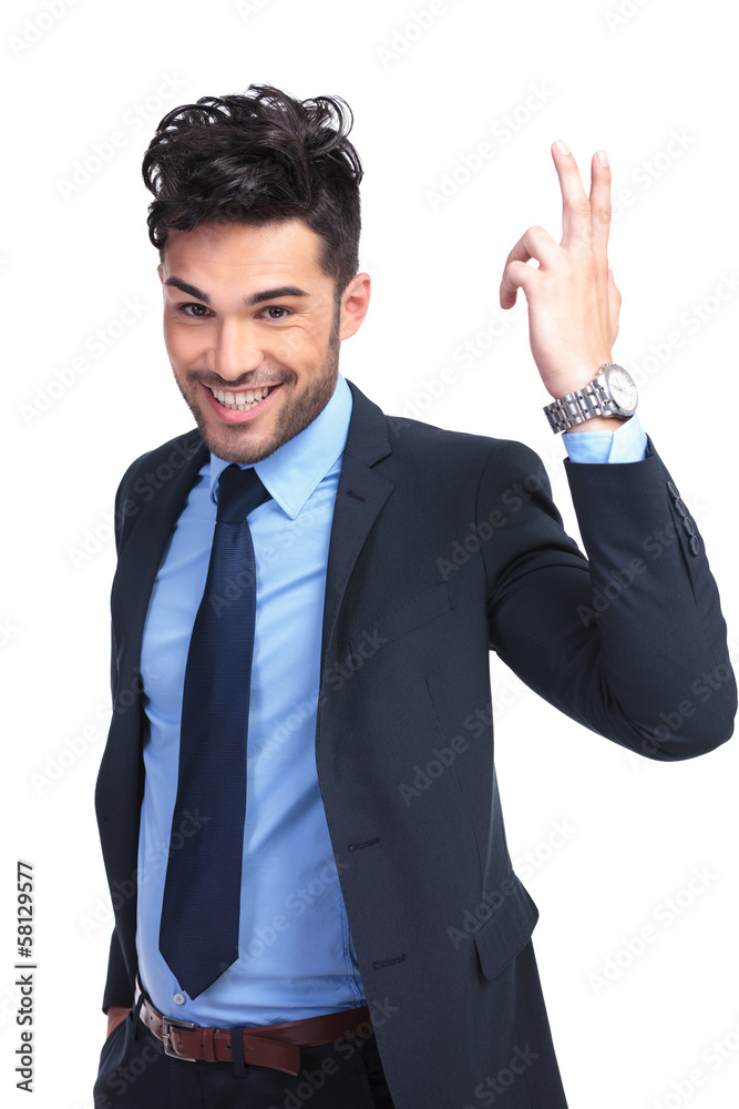 smiling young business man making a greeting hand gesture Stock Photo ...