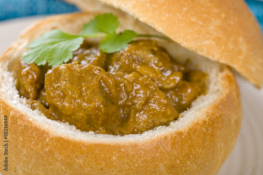 Bunny Chow - South African mutton curry inside a bread bun Stock Photo ...