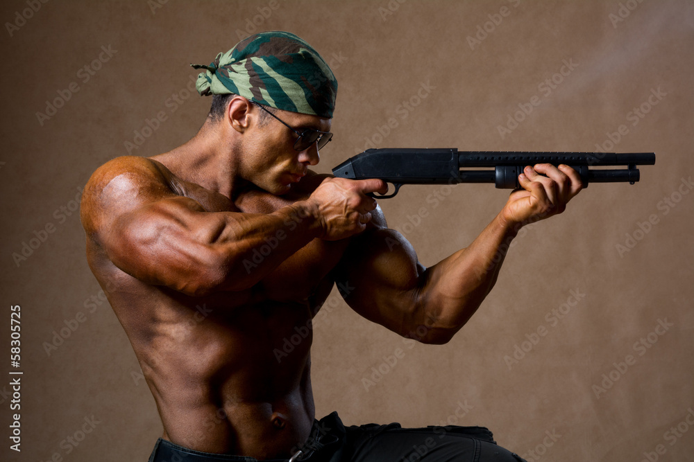 Strong athletic man with a gun. Special Forces 素材庫相片 | Adobe Stock