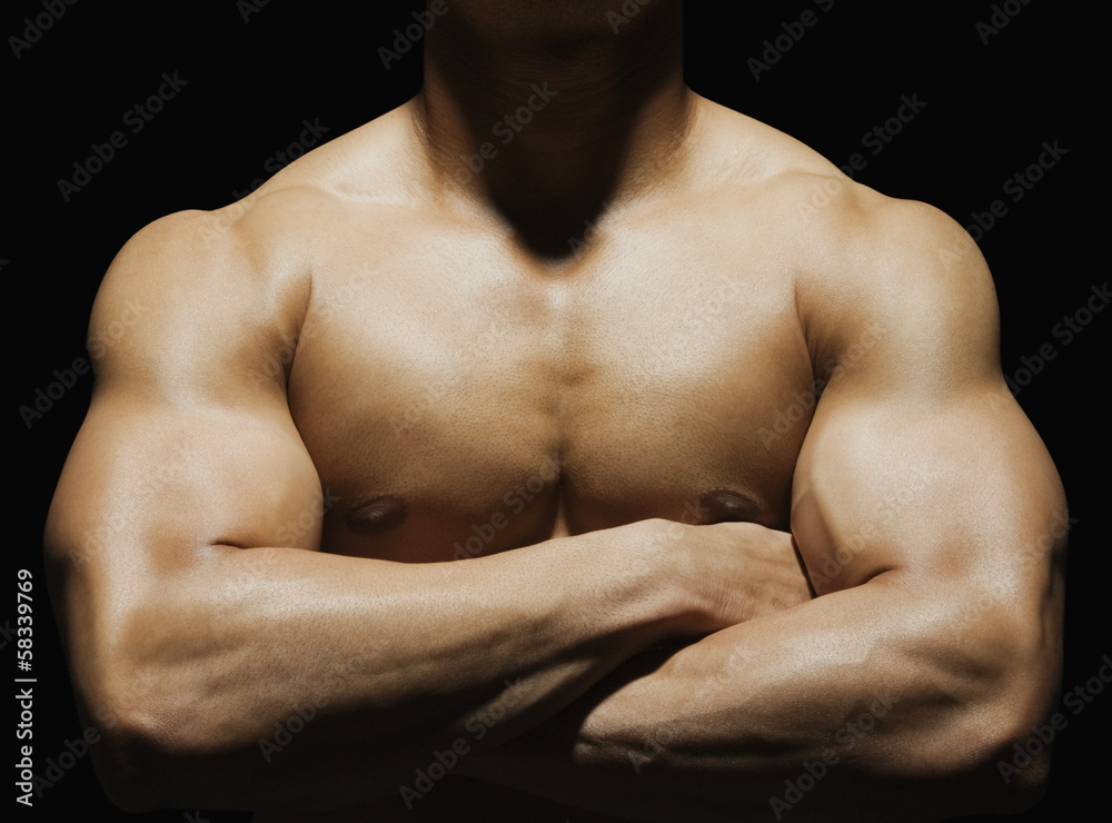 Close-up of a muscular man showing his muscles Stock Photo | Adobe Stock