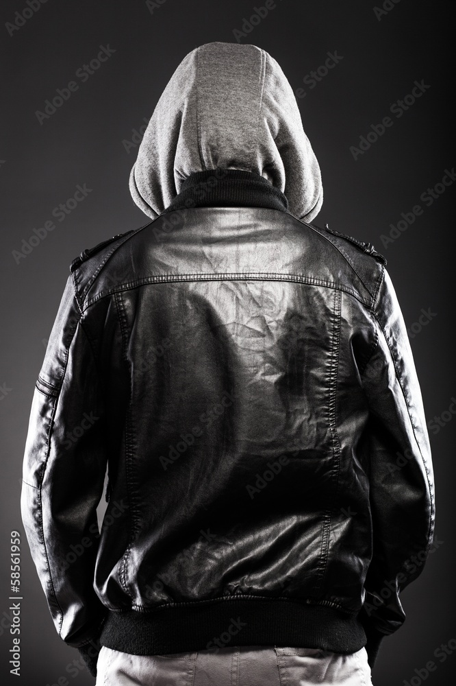 Young man in leather jacket and hood rear view Stock 写真 | Adobe Stock
