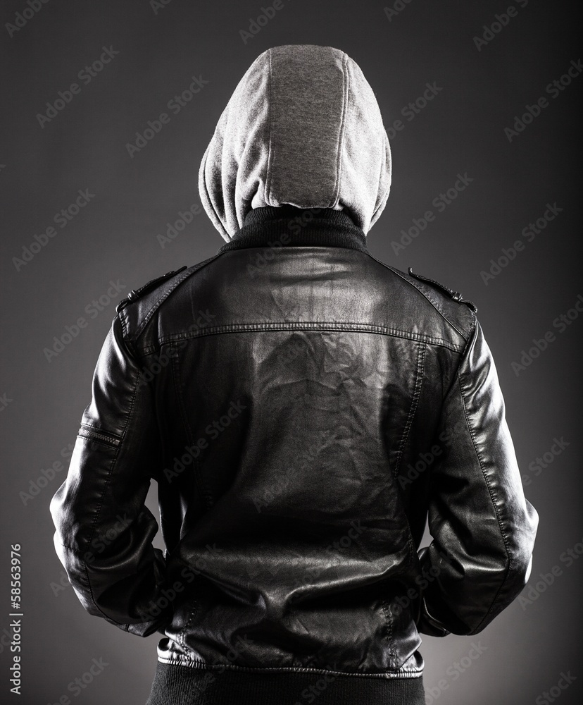 Young man in leather jacket and hood rear view Stock Photo | Adobe Stock