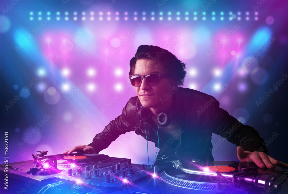 Disc jockey mixing music on turntables on stage with lights and Stock ...