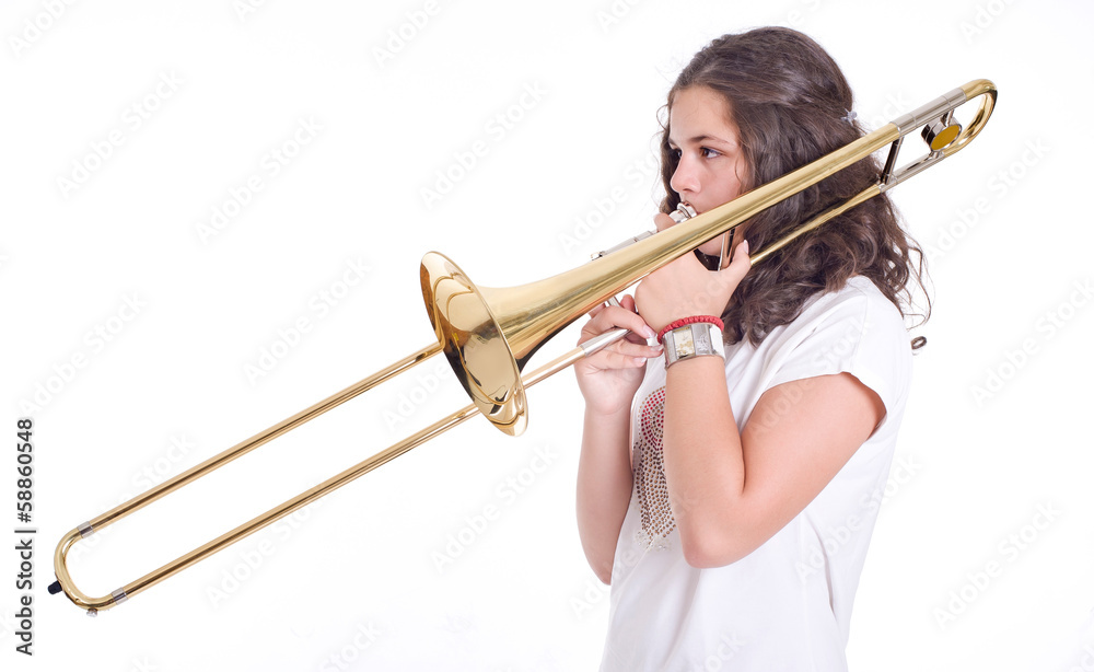 Foto de Teenage girl playing the trombone do Stock | Adobe Stock