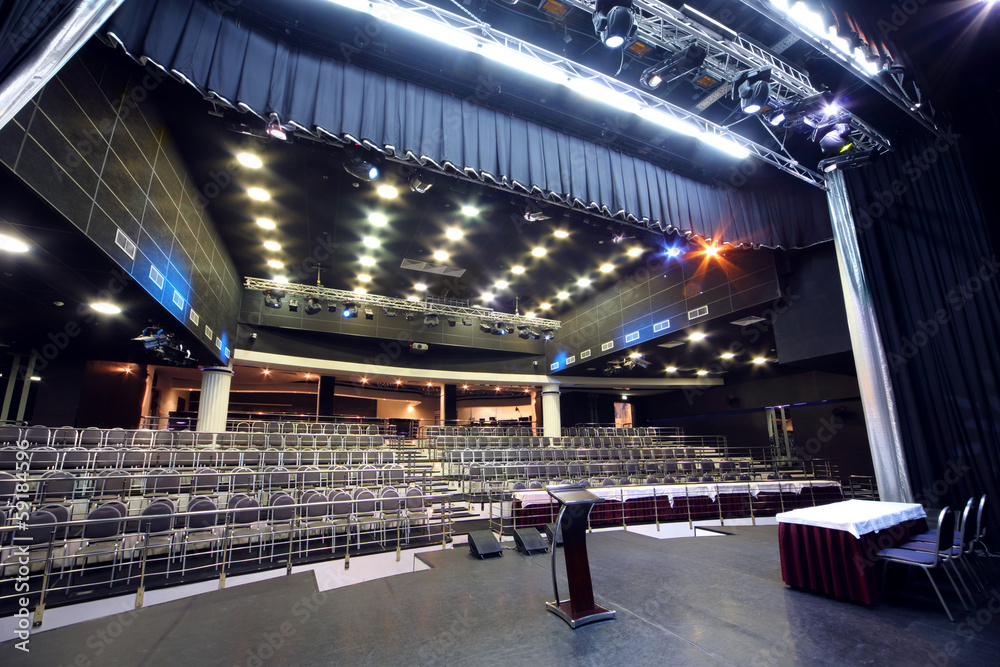 Document stand and table on stage and rows of seats Stock Photo | Adobe ...