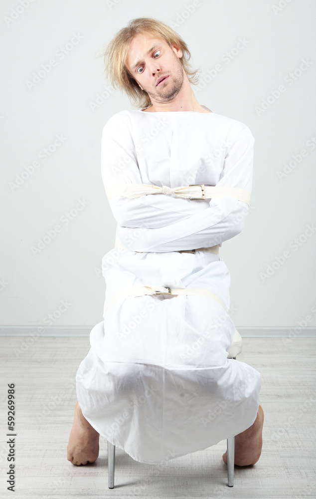 Mentally ill man in strait-jacket on gray background Stock 写真 | Adobe Stock