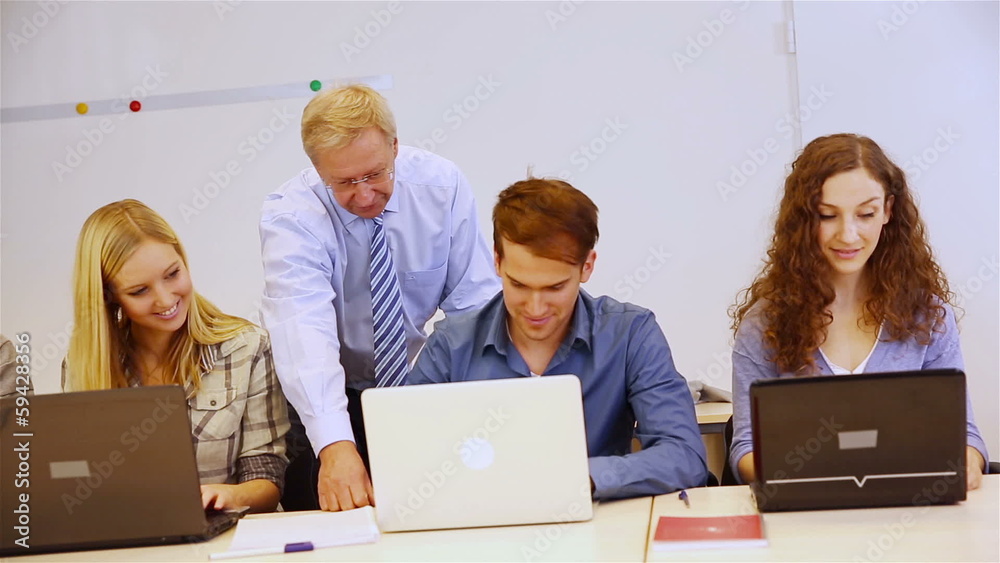 Students and teacher working on computer Stock Video | Adobe Stock