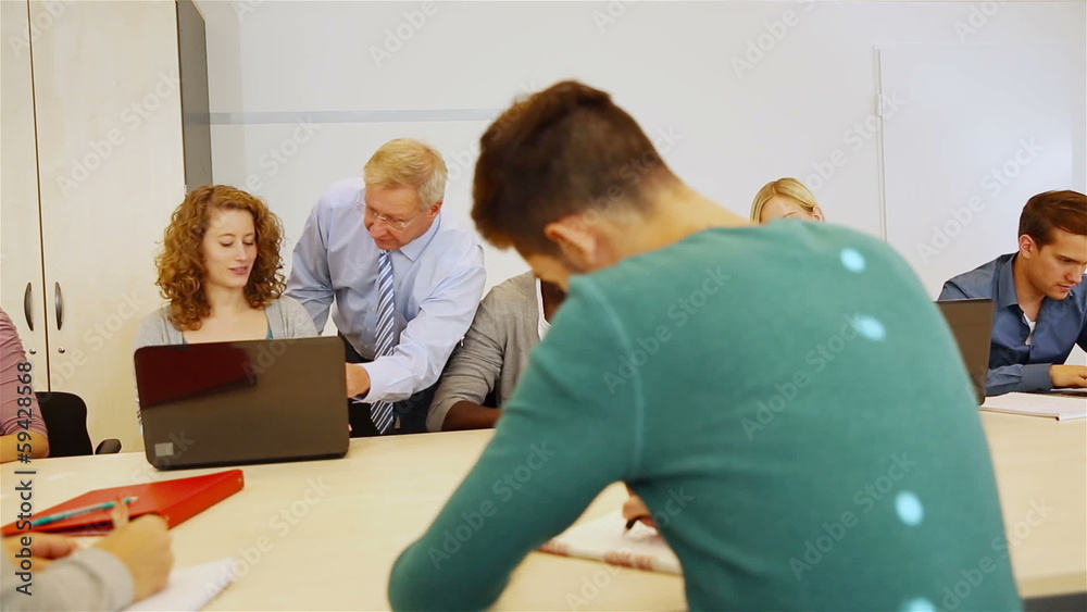 Teacher teaching teenager in classroom Stock Video | Adobe Stock