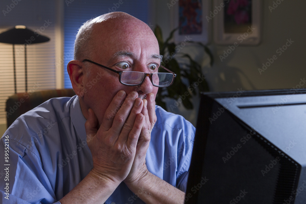 Older man shocked as he reads his computer monitor, horizontal Stock ...