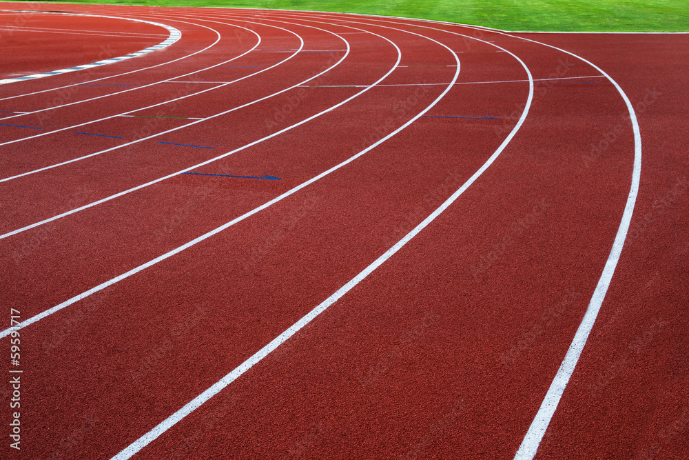 White lines on red running track with green grass. Stock Photo | Adobe ...