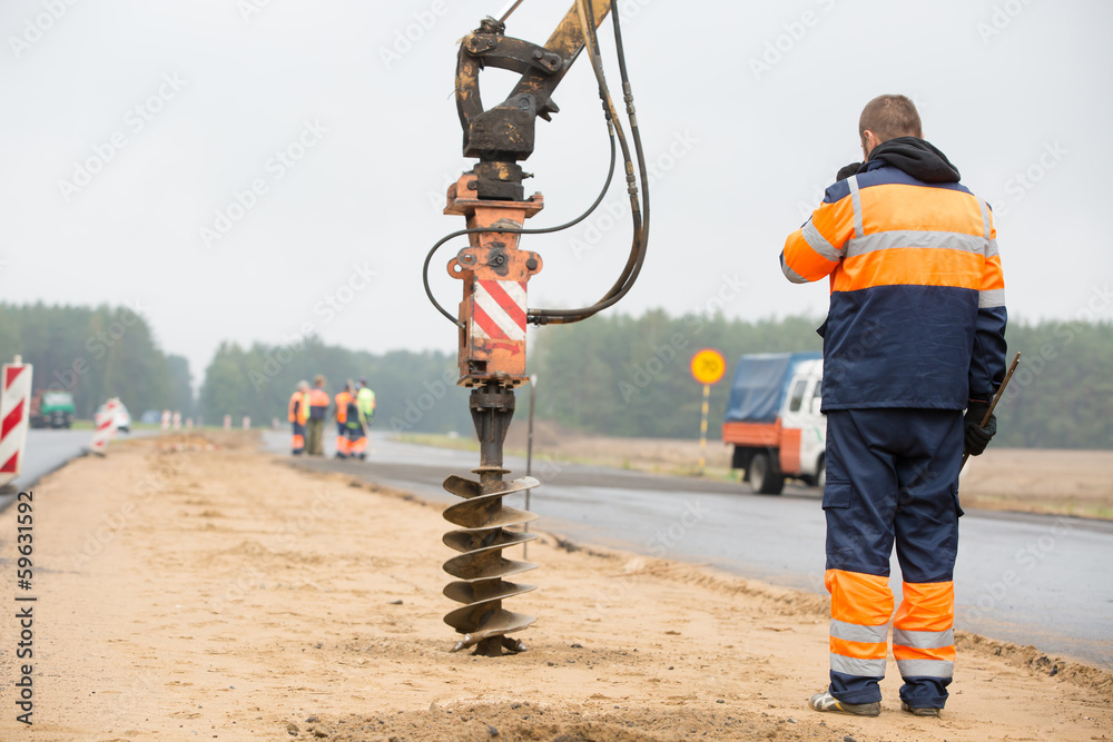 Builder worker monitoring drilling holes Stock Photo | Adobe Stock