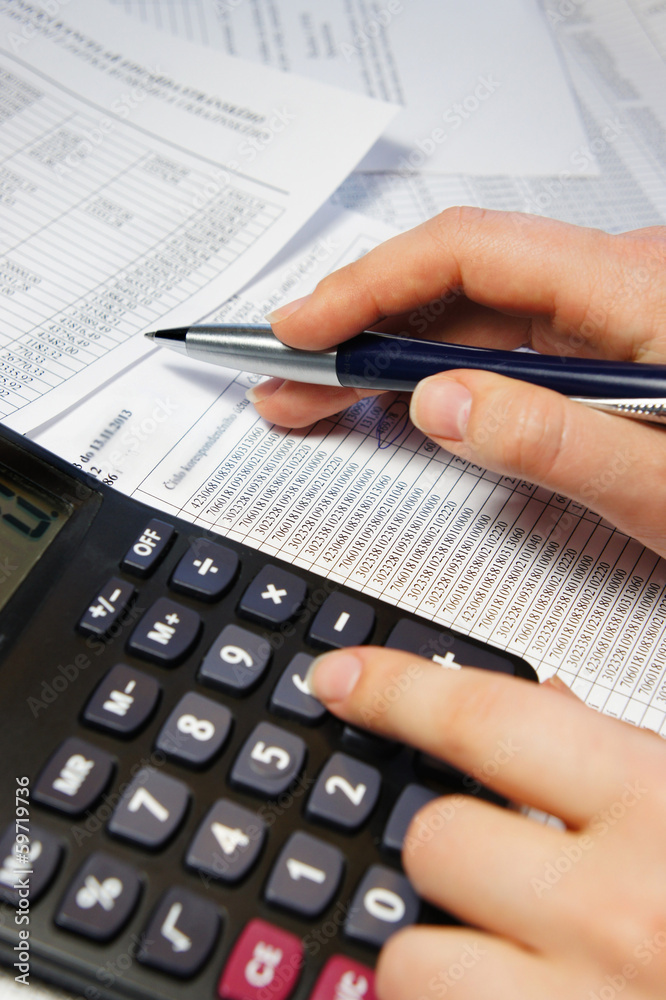 Office table with calculator, pen and accounting document Stock Photo ...
