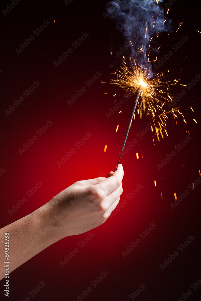 sparkler in hand Stock Photo | Adobe Stock