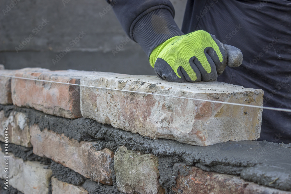 Installing brick, build a brick wall 2 Stock Photo | Adobe Stock