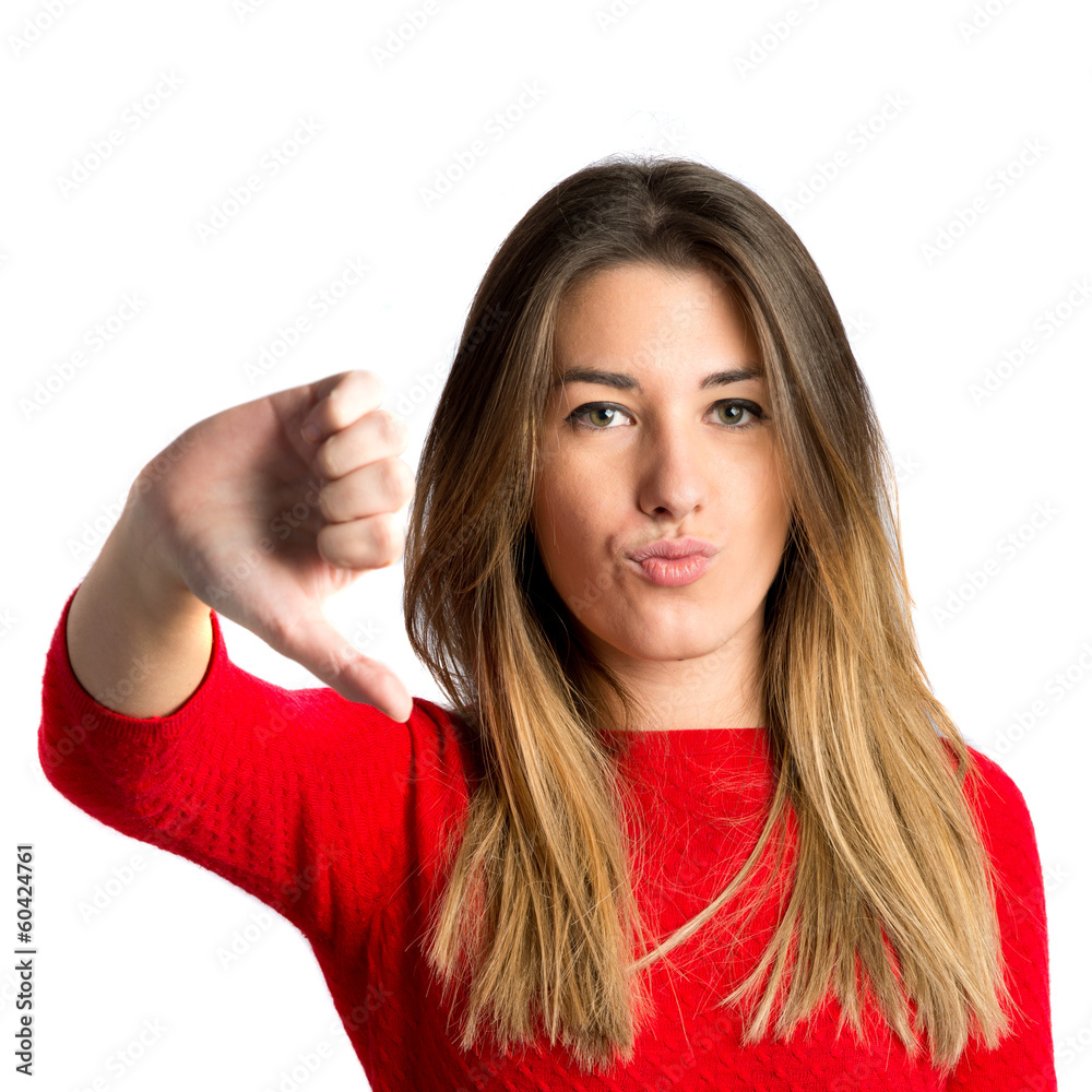 Young girl doing a bad signal over white background Stock Photo | Adobe ...