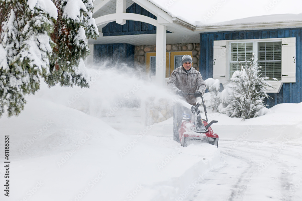 Man clearing driveway with snowblower Stock Photo | Adobe Stock Man clearing driveway with snowblower Stock Photo | Adobe Stock