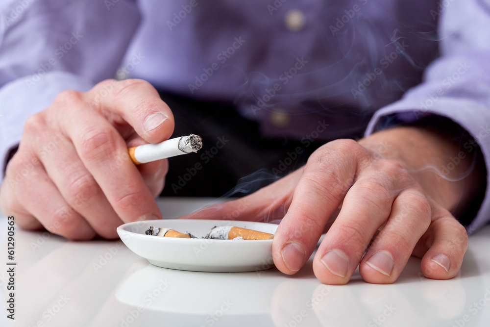 Man using ashtray Stock Photo | Adobe Stock