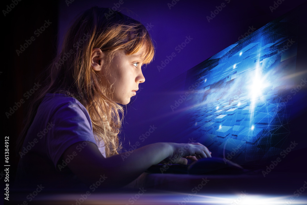 Little blond girl working on computer in dark room at night Stock Photo ...