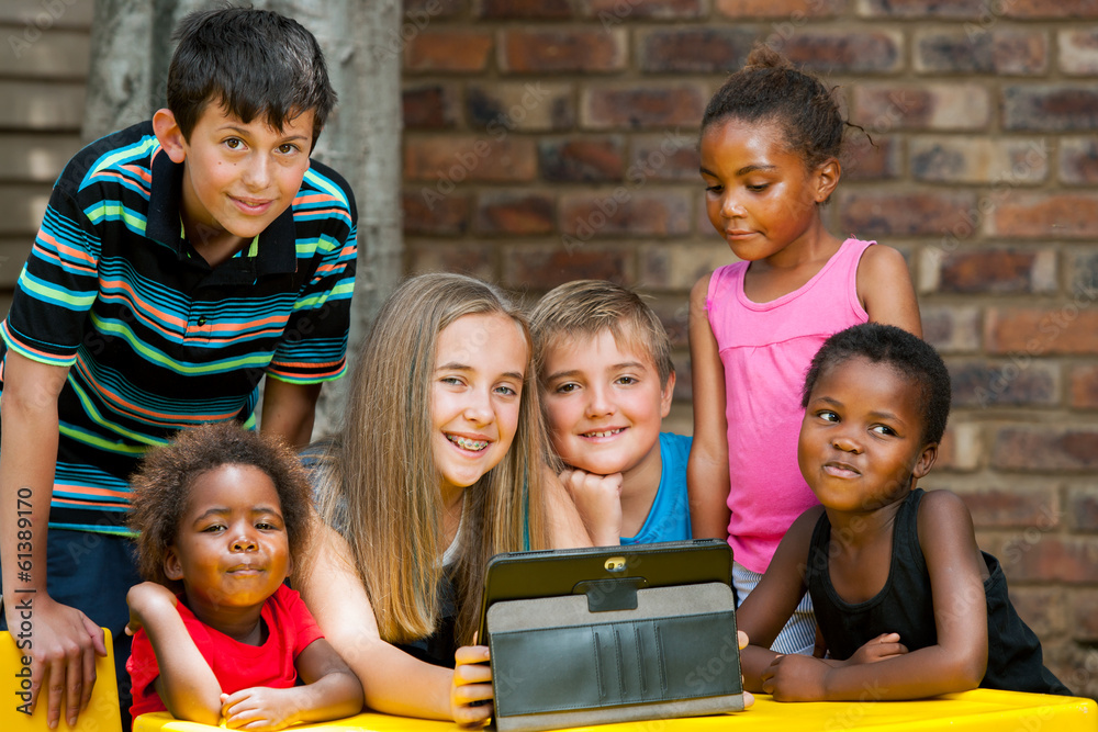 Bunch of kids playing on tablet. Stock Photo | Adobe Stock