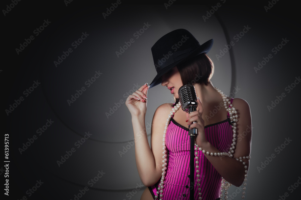 Beautiful singer in black hat singing with a retro microphone Stock ...