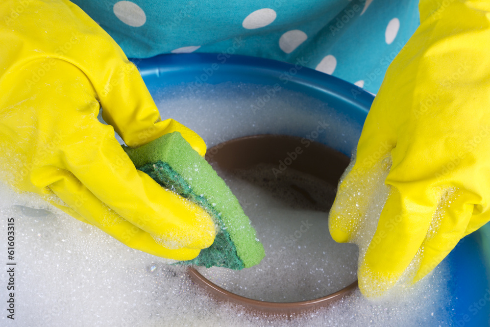Housewife washing dishes in wash-basin Stock Photo | Adobe Stock