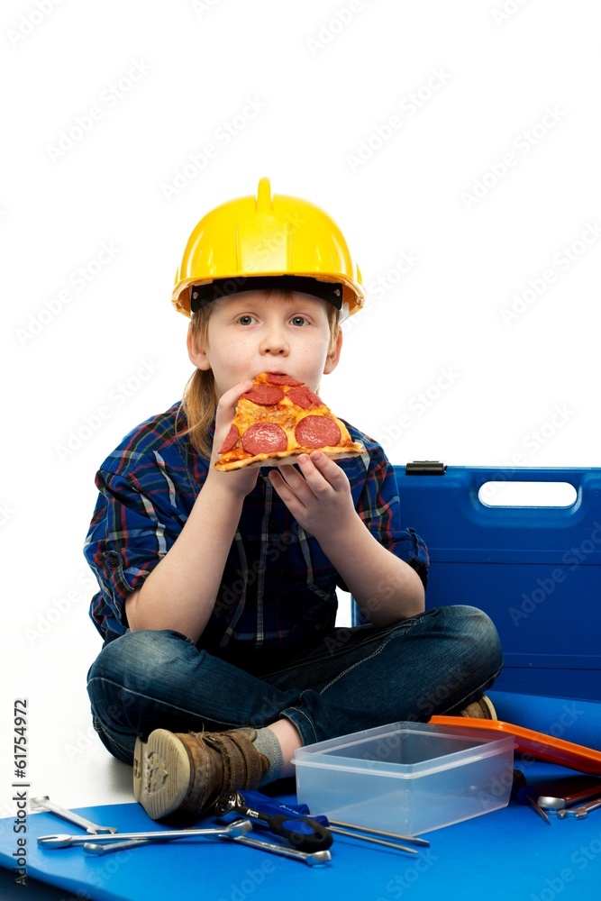 Little funny mechanic boy eating pizza among tools Stock Photo | Adobe ...