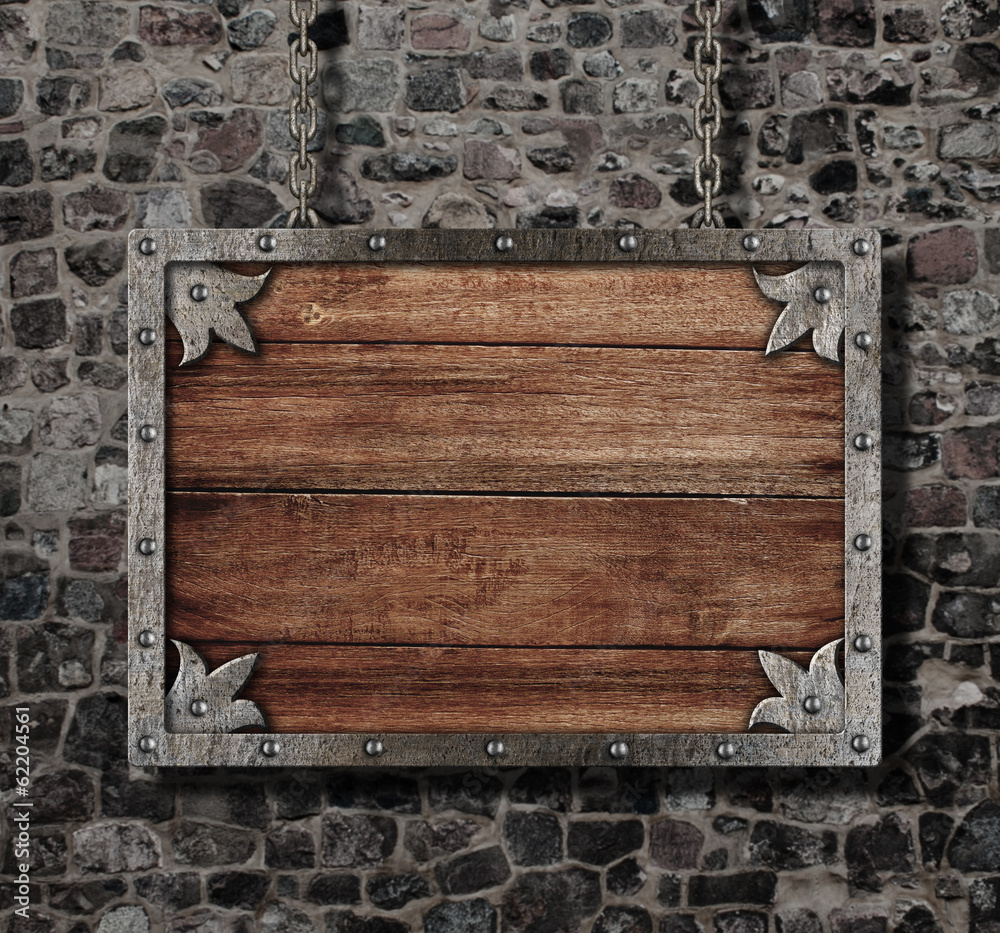 medieval old sign with chain on stone wall Stock Photo | Adobe Stock