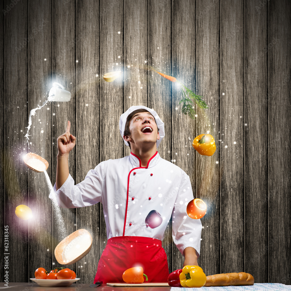 Cook at kitchen foto de Stock | Adobe Stock