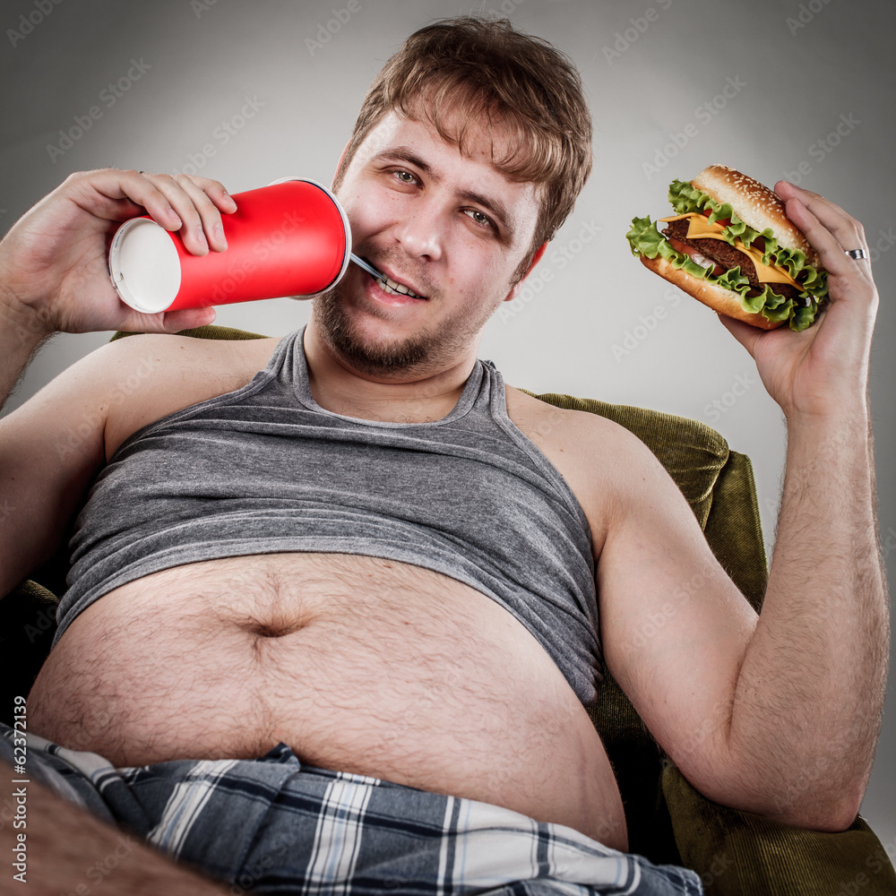 Fat man eating hamburger Stock Photo | Adobe Stock