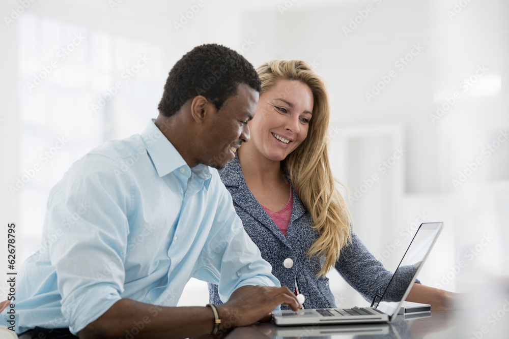 Office Interior. A Couple Seated Side By Side At A Computer. Stock ...