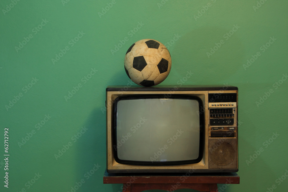 An old soccer ball on a retro TV with retro green paint wall Stock ...