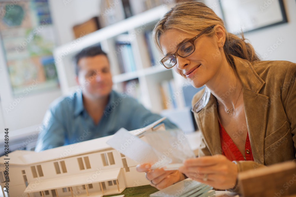 Two people working on a green construction project. A computer and an ...