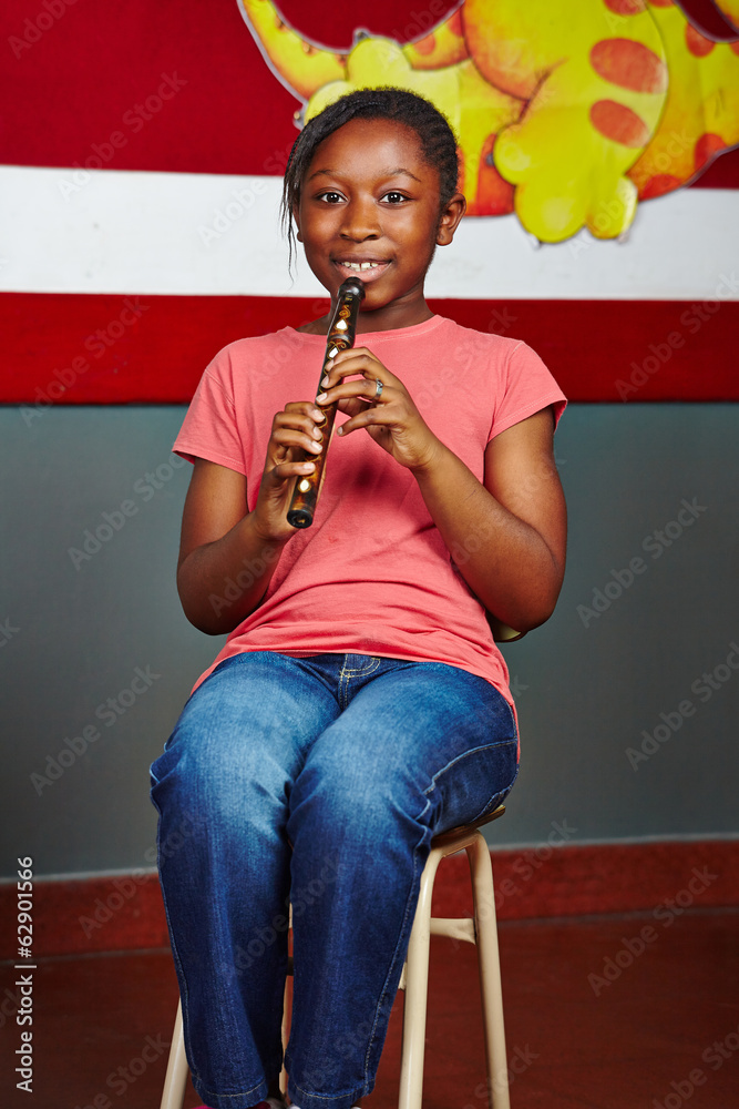 Girl learning to play music instrument Stock Photo | Adobe Stock