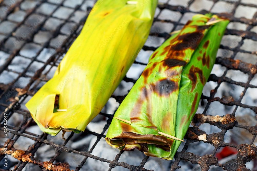 Sticky rice wrapped in banana leaves grill Stock Photo | Adobe Stock