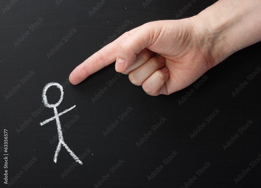 Giant Hand pointing at stick figure on a blackboard Stock Photo | Adobe ...