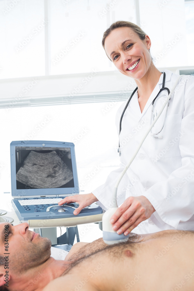 Doctor using ultrasound scan on male patient Stock Photo | Adobe Stock