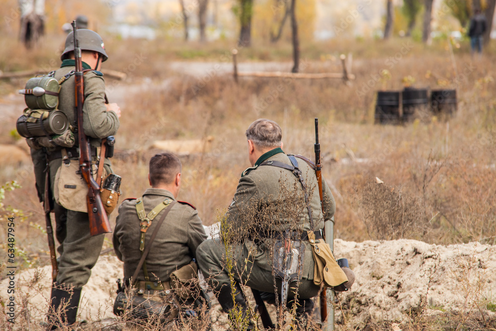German WWII soldiers reading newspaper in trench Stock Photo | Adobe Stock