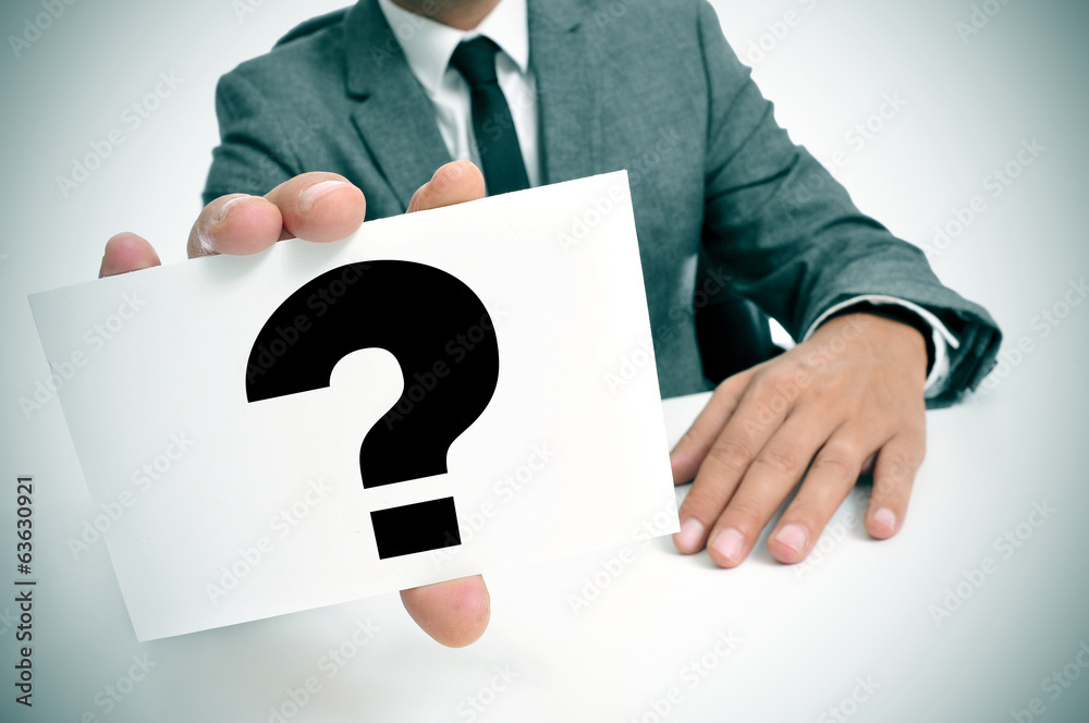 man in suit holding a signboard with a question mark Stock Photo ...