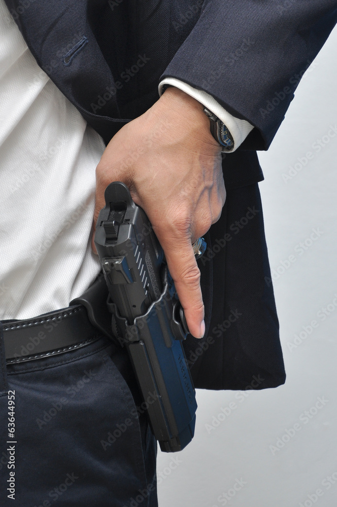 Photo & Art Print Agent wearing white shirt drawing gun from holster ...