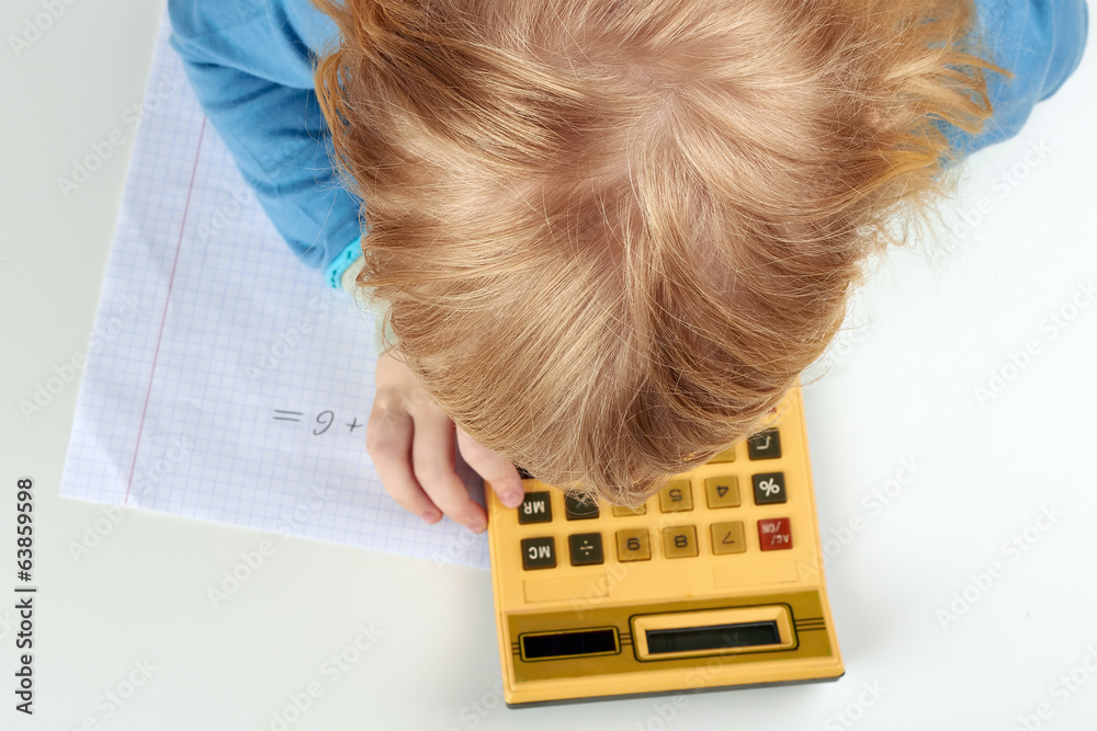 child does calculations with retro calculator Stock Photo | Adobe Stock