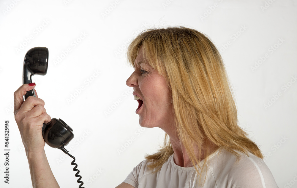 Angry woman shouting into a telephone Stock Photo | Adobe Stock