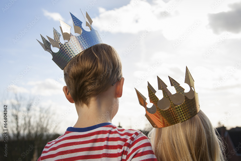 Two children in fancy dress, wearing crowns. Stock Photo | Adobe Stock