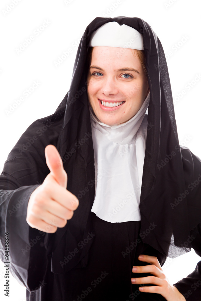 Young nun showing thumbs up sign and smiling Stock Photo | Adobe Stock