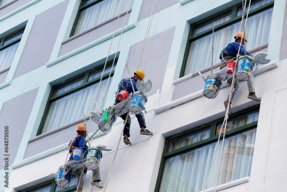 Worker are painting the color in high rise buildings. Stock Photo ...