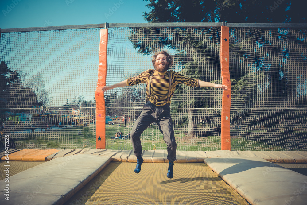 man jumping on trampoline at playground Stock Photo | Adobe Stock