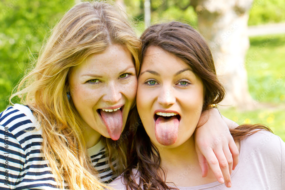 Two girls sticking tongue out Stock Photo | Adobe Stock